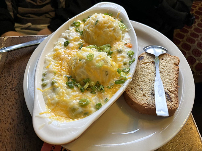 Look at those twin peaks of potato perfection, sprinkled with green onions like confetti celebrating the party of flavors happening underneath.