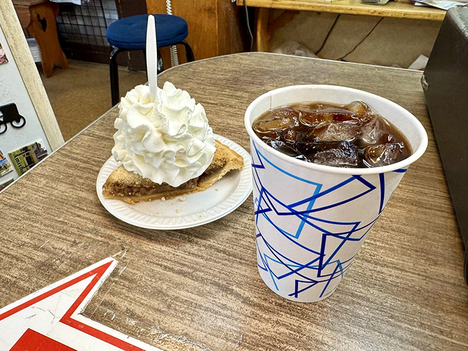 The perfect Lancaster County pairing: a slice of shoo-fly pie with whipped cream alongside an ice-cold drink. Simple pleasures at their finest.