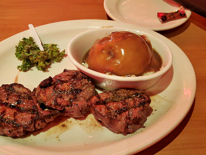 Steak medallions posed with military precision next to a volcanic potato eruption that's melting into creamy submission. Kale provides moral support.