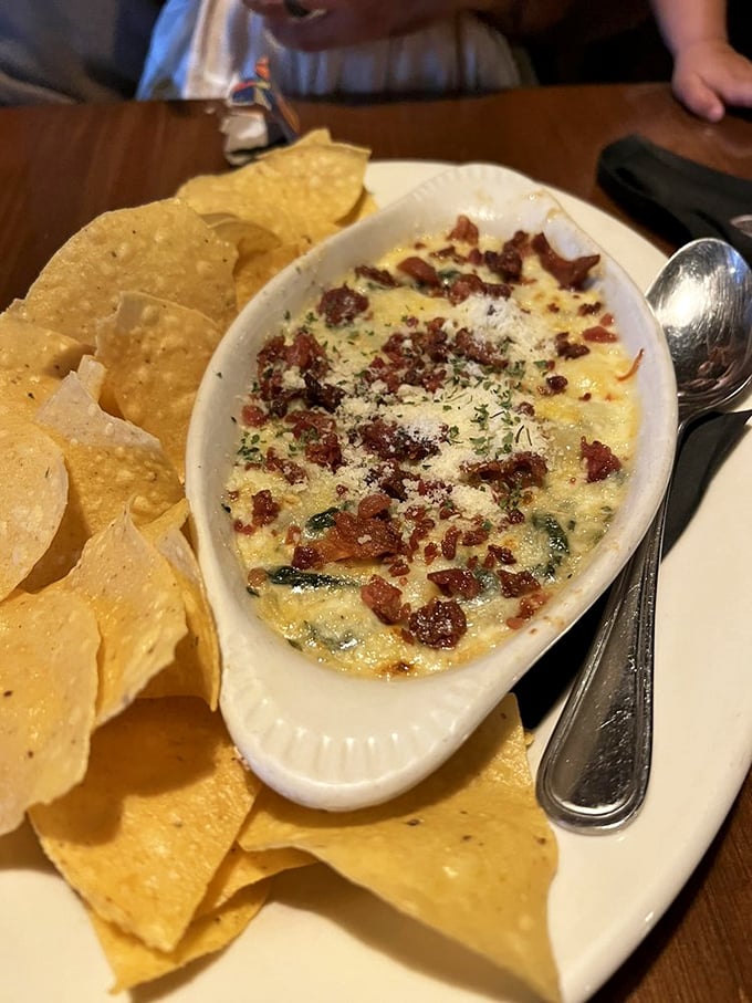 This spinach dip, crowned with bacon bits and surrounded by tortilla chips, isn't just an appetizer&mdash;it's the opening act that threatens to steal the show.