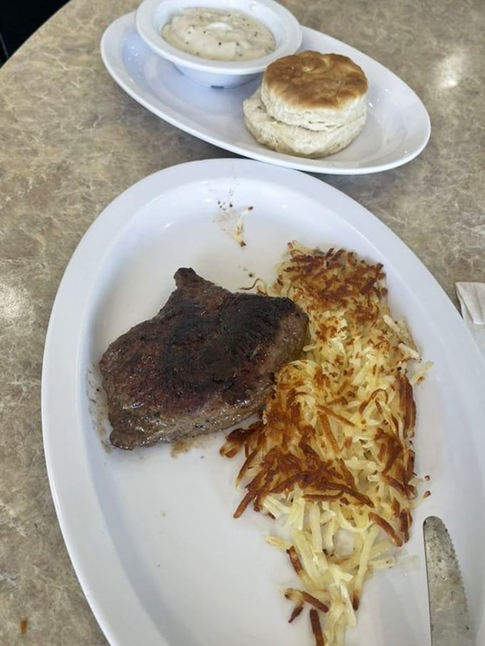 When steak meets breakfast, magic happens. Those hash browns have achieved the golden-brown perfection that home cooks spend lifetimes trying to master.