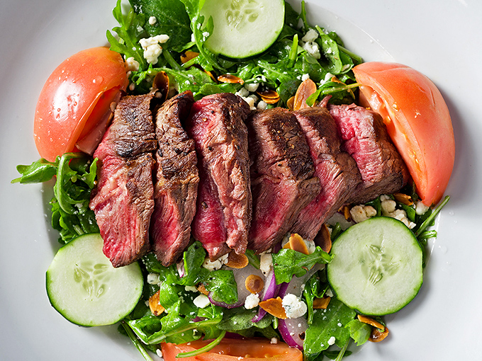 "Who ordered a salad at a steakhouse?" becomes "Why haven't I always ordered this?" Perfectly pink slices transform ordinary greens into something extraordinary.