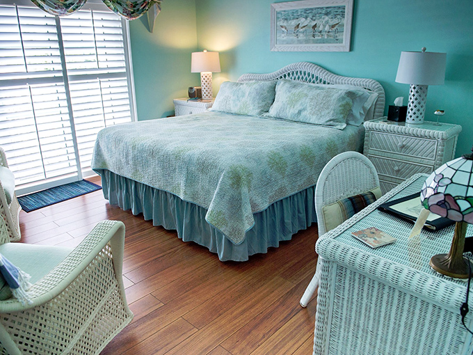 The Summer Garden room wraps you in soothing aqua hues and wicker furnishings, creating a coastal retreat that's one part beachy, two parts sophisticated.