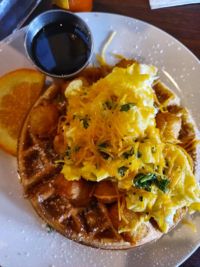 Eggs and cheese lounging on a waffle like they've found their forever home. The breakfast equivalent of winning the lottery.