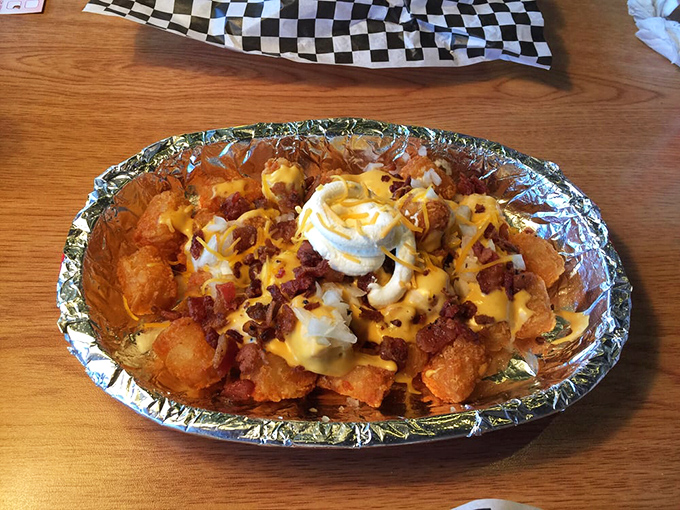 Peppers dance atop this loaded hot dog while crispy onion rings stand at attention nearby. A duo that proves some of the best relationships are food-based.