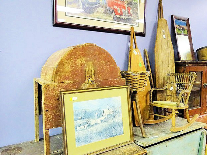 A winter scene painting nestled among wooden treasures. The kind of rustic Americana that makes you want to sip hot cider in a rocking chair.