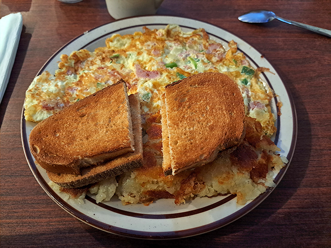 This Western omelet and toast combo isn't just breakfast; it's a sunrise on a plate that makes waking up early almost seem reasonable.