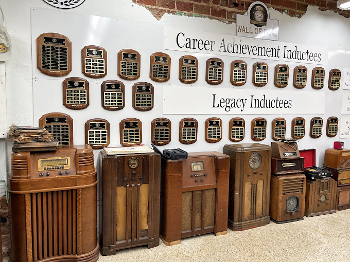 These vintage radios and plaques tell stories of a time when families gathered around furniture to hear the news, not scroll through it.