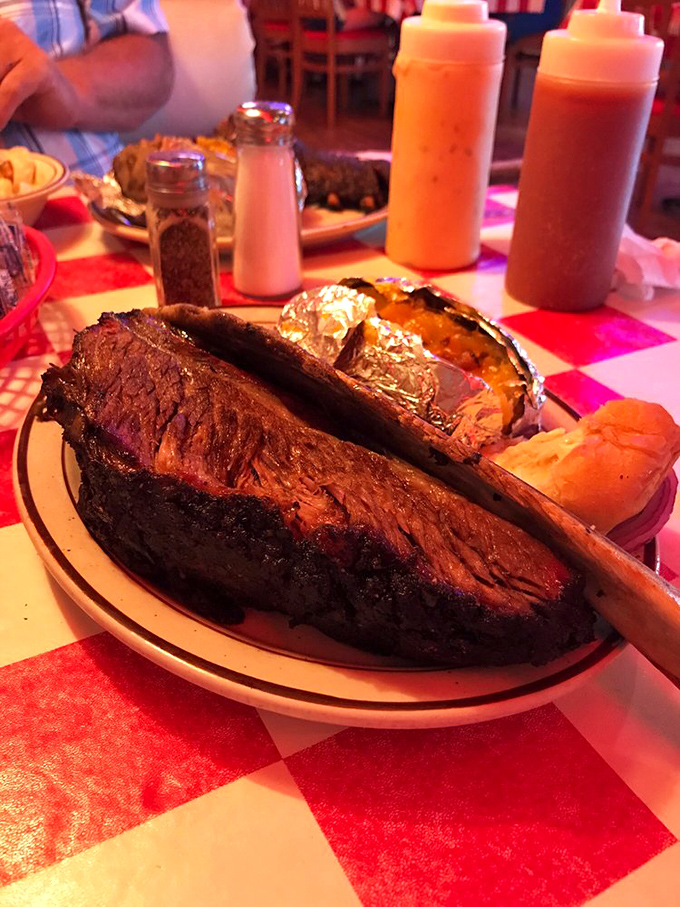 Brisket and baked potato&mdash;a romance for the ages. Those sauce bottles standing by like eager matchmakers ready to enhance the relationship.