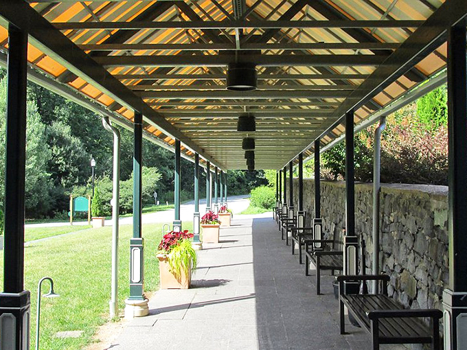 A covered walkway that practically begs for a slow promenade, where Victorian ladies might have strolled while discussing the weather, politics, or the latest scandalous novel.