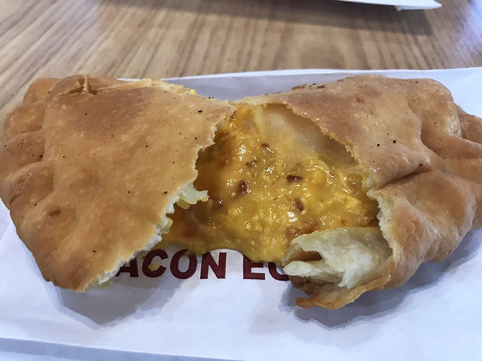 Breakfast reimagined&mdash;eggs and cheese peeking through a golden crust. Morning commuters, your drive-thru donut has met its match.