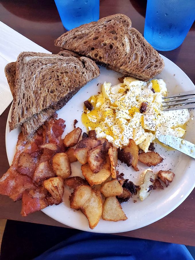 The breakfast trinity of crispy-edged eggs, perfectly bronzed toast, and home fries that somehow manage to be both crispy and tender&mdash;a morning miracle.