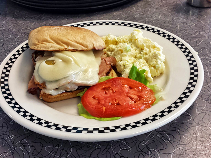 This breakfast sandwich isn't just a meal, it's architecture&mdash;layers of melted cheese, protein, and fresh tomato creating the Taj Mahal of morning sustenance.