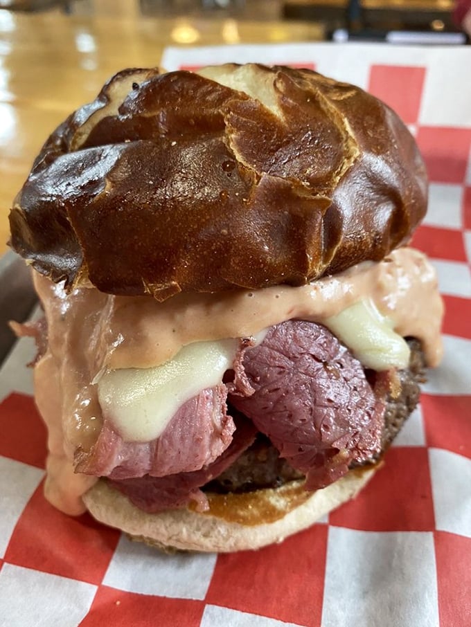 This isn't just a burger; it's a masterclass in sandwich architecture. The pretzel bun cradles its precious cargo like it was born for this purpose.