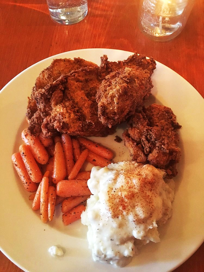 Fried chicken that shatters with each bite, paired with mashed potatoes that could make a Thanksgiving table jealous.