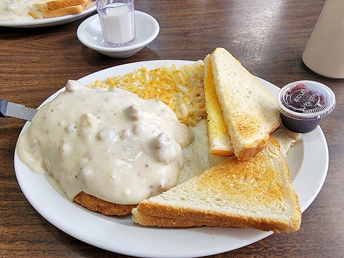 Country gravy cascading over chicken fried steak like a comfort food waterfall&mdash;this is what breakfast dreams are made of. 