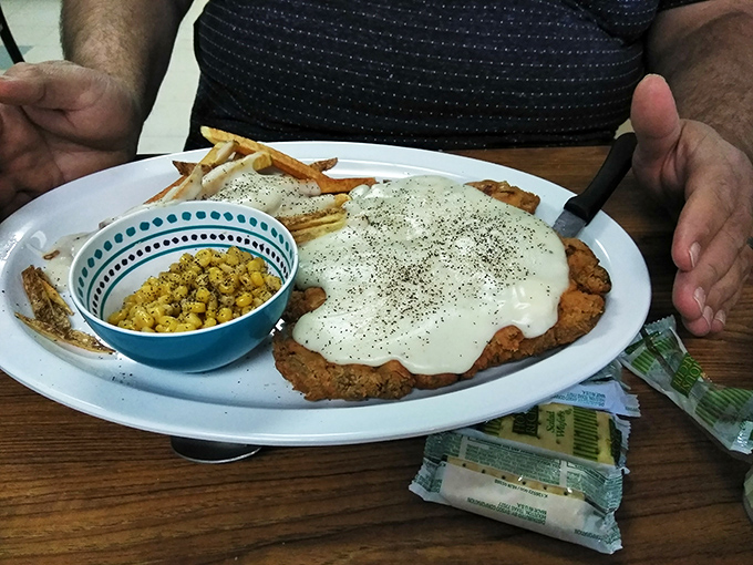 That chicken fried steak isn't just covered in gravy&mdash;it's swimming in a creamy pepper-flecked pool that deserves Olympic recognition.