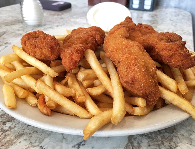 Chicken tenders and fries that could make a food photographer weep. The kind of comfort food that feels like a hug from your favorite aunt.