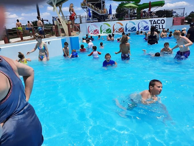 The water slide tower stands like a colorful monument to joy &ndash; each twist and turn engineered specifically for maximum squealing and minimal dignity.