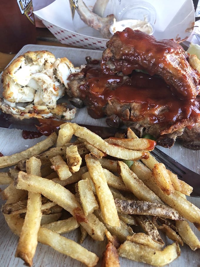 The ultimate surf-and-turf showdown: sauce-slathered ribs challenging a crab cake for palate supremacy. No losers in this delicious competition.