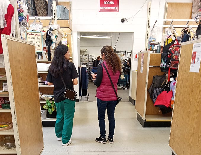 The universal language of thrift store discovery. Two shoppers share that "should I or shouldn't I?" moment we've all experienced.