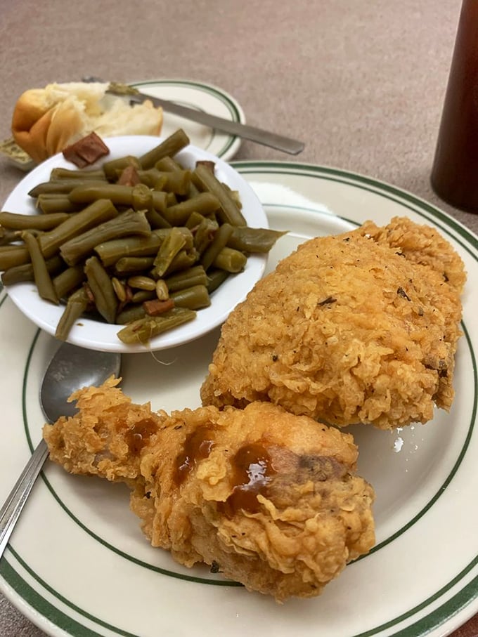 Fried chicken so perfectly golden it belongs in Fort Knox, paired with green beans that actually taste like vegetables should. 