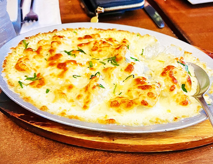 Baked gnocchi swimming in a golden sea of cheese&mdash;proof that heaven isn't a place, it's a dish served on an oval plate.