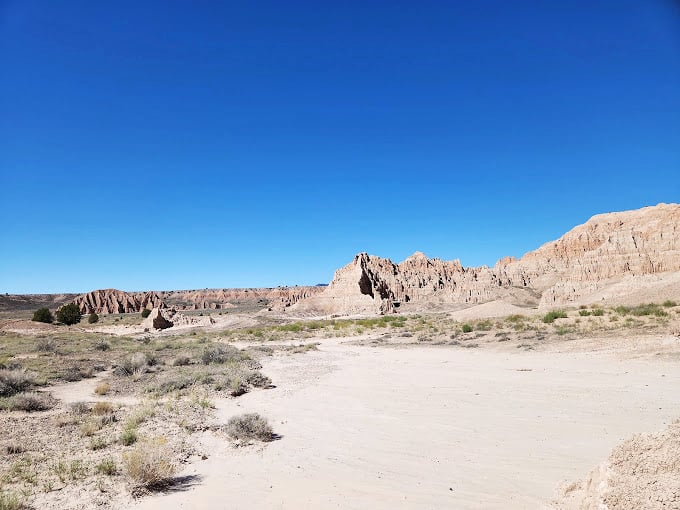 The vastness of Cathedral Gorge stretches toward the horizon. Even the clouds seem to pause here, admiring what water and wind have sculpted below.