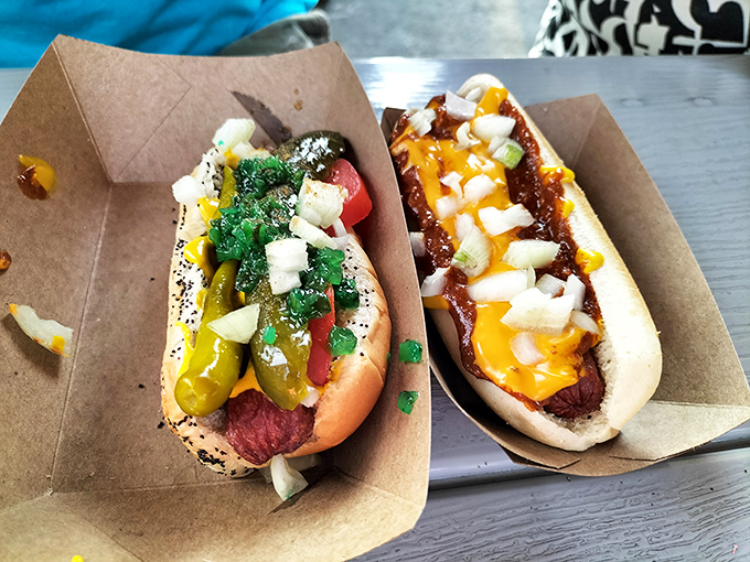 A study in contrasts: Chicago-style with its vegetable garden toppings alongside a chili cheese masterpiece. Two different philosophies, both absolutely right.