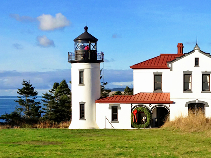 Admiral of the shoreline: The Admiralty Head Lighthouse stands sentinel, its crisp white tower and red roof a beacon of maritime history.