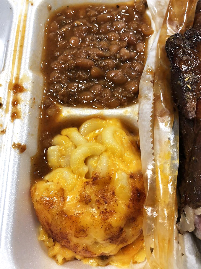 These aren't just sides&mdash;they're co-stars. The beans rich with smoky essence, the mac and cheese wearing a golden crust like a crown.