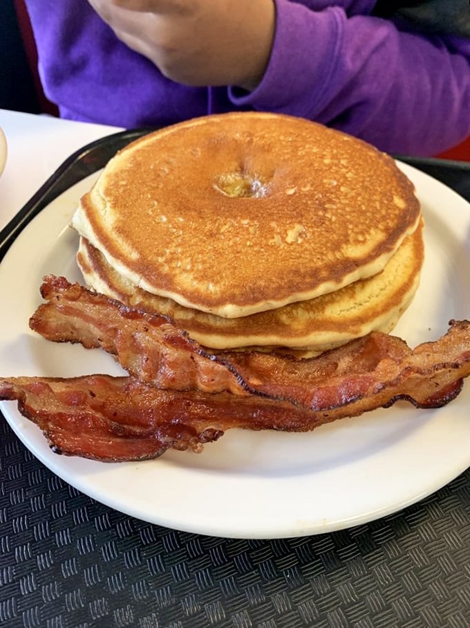 These pancakes stack up like golden vinyl records, with that crispy-edged bacon playing the perfect accompanying track.