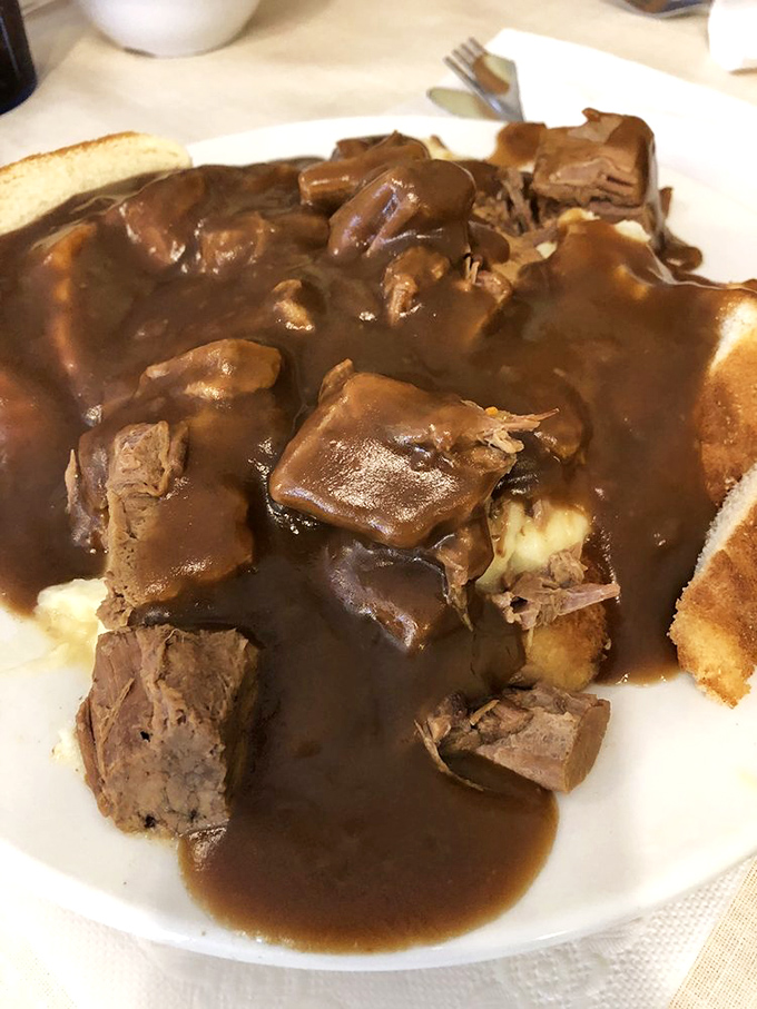 Pot roast so tender it had to retire early, swimming in gravy rich enough to apply for its own tax bracket.