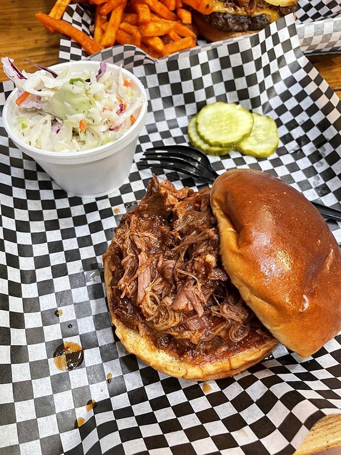 This pulled pork sandwich isn't just food &ndash; it's an architectural masterpiece of tender meat, tangy sauce, and pillowy bun.