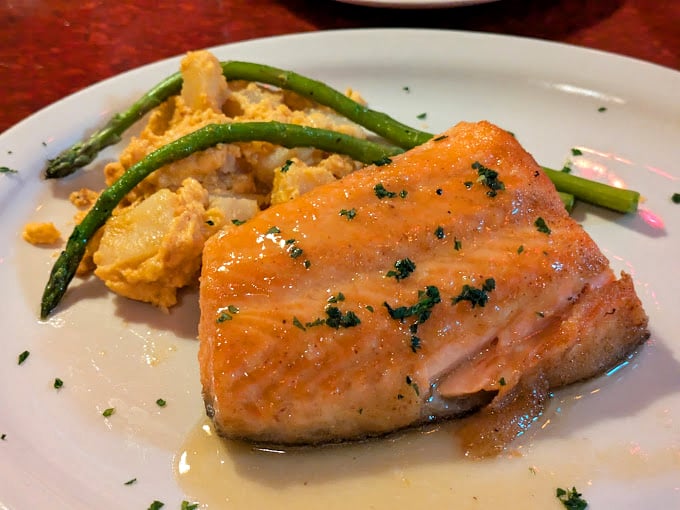 Salmon so perfectly cooked it practically glows. Paired with creamy potatoes and asparagus, it's the seafood equivalent of a standing ovation.