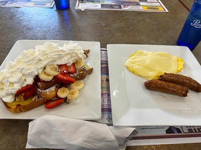 French toast so decadent it deserves its own zip code, accompanied by strawberries and bananas that didn't know they could reach such heights of breakfast glory.