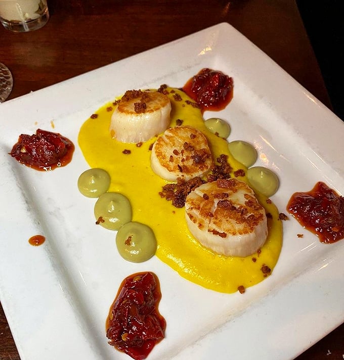 These seared scallops aren't just dinner&mdash;they're edible jewels from the Atlantic, served on a golden sauce canvas with artistic splashes of tomato jam.