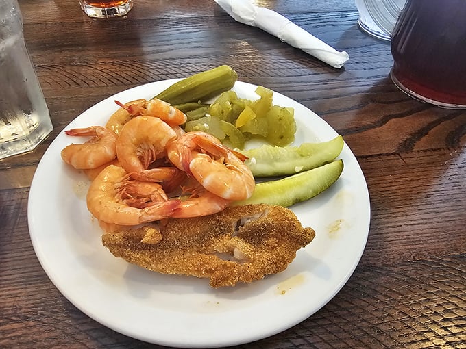Simple pleasures done right: plump shrimp, cornmeal-crusted catfish, and all the fixings. No foam, no fuss, just flavor.