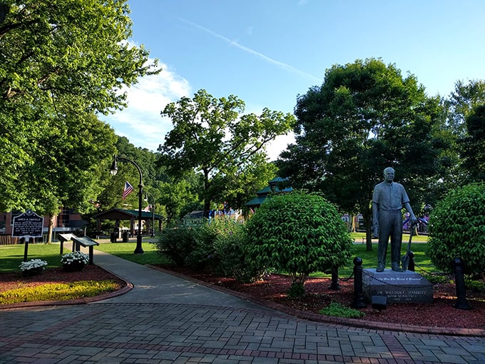 A quiet moment in the town square, where bronze statues and manicured gardens create pockets of reflection amid the Appalachian hustle.