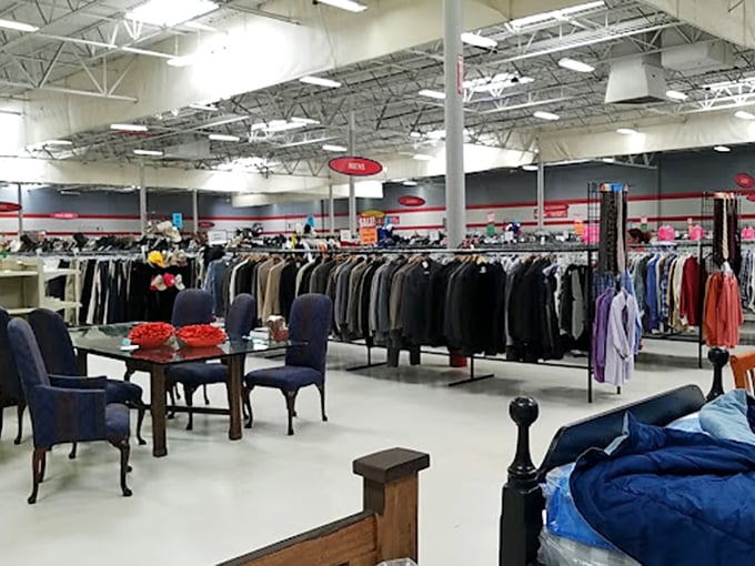 Elegant dining chairs surround a glass table like aristocrats at a formal dinner, while nearby a red sofa dreams of Netflix marathons.