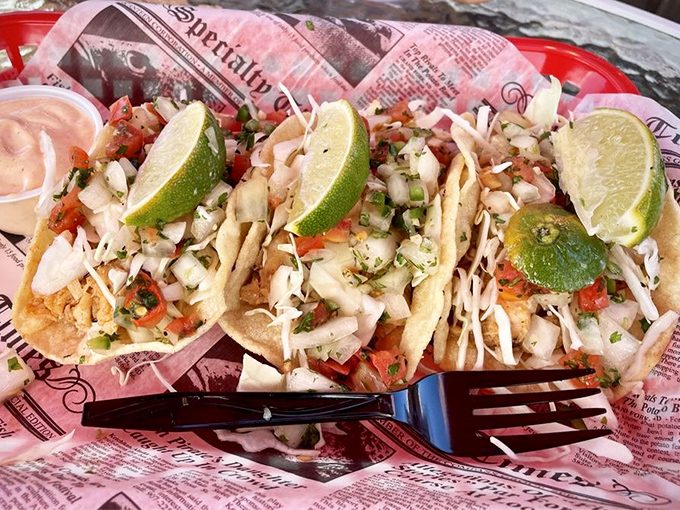These fish tacos aren't just a meal—they're a fiesta on recycled newspaper. Fresh cabbage, zesty pico, and lime wedges transform local catch into handheld happiness.