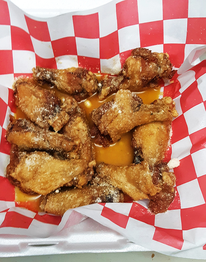 Wings bathed in sauce that walks the perfect line between sweet and heat. The red-checkered paper isn't just nostalgic&mdash;it's catching flavor you'll want to lick off later.