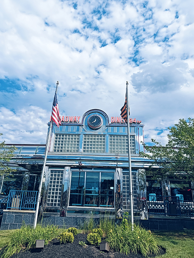 Broadway Diner gleams under Maryland skies like a chrome promise of eggs over easy and conversations that flow even easier.