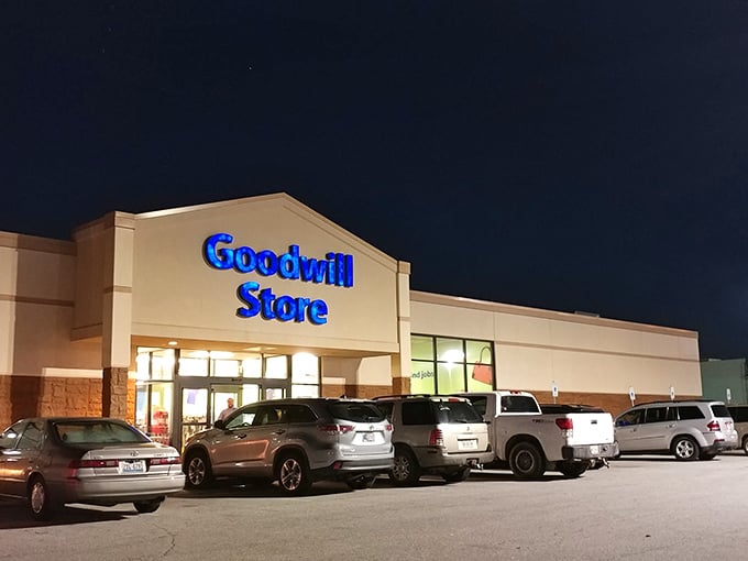 Goodwill's glowing sign beckons night owls to bargain hunt after dark. Even at night, the thrill of the find never sleeps!