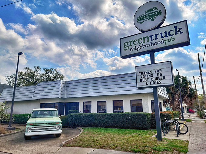 Green Truck Pub's vintage sign and classic white building house burger magic that makes locals proud and visitors jealous.