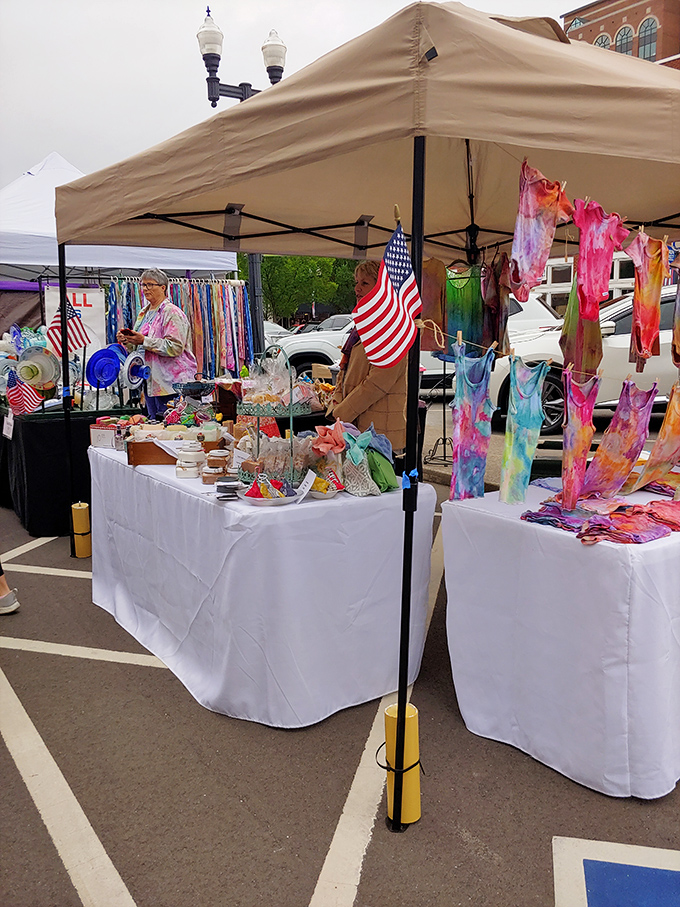 The makeshift marketplace transforms parking spaces into an impromptu village conversation.