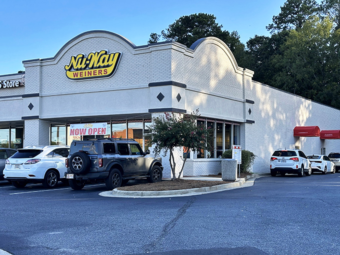 Nu-Way's distinctive curved architecture stands out like its famous red wieners. A Macon landmark where hot dog dreams come true since 1916.