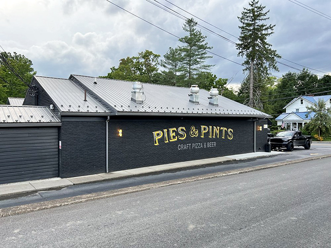 Pies & Pints' sleek black exterior – the Clark Kent disguise for a superhero pizza experience inside.