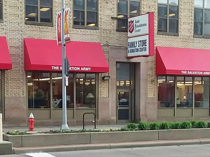 The Salvation Army's classic brick building with signature red awnings&mdash;where retail therapy and good deeds create perfect harmony.