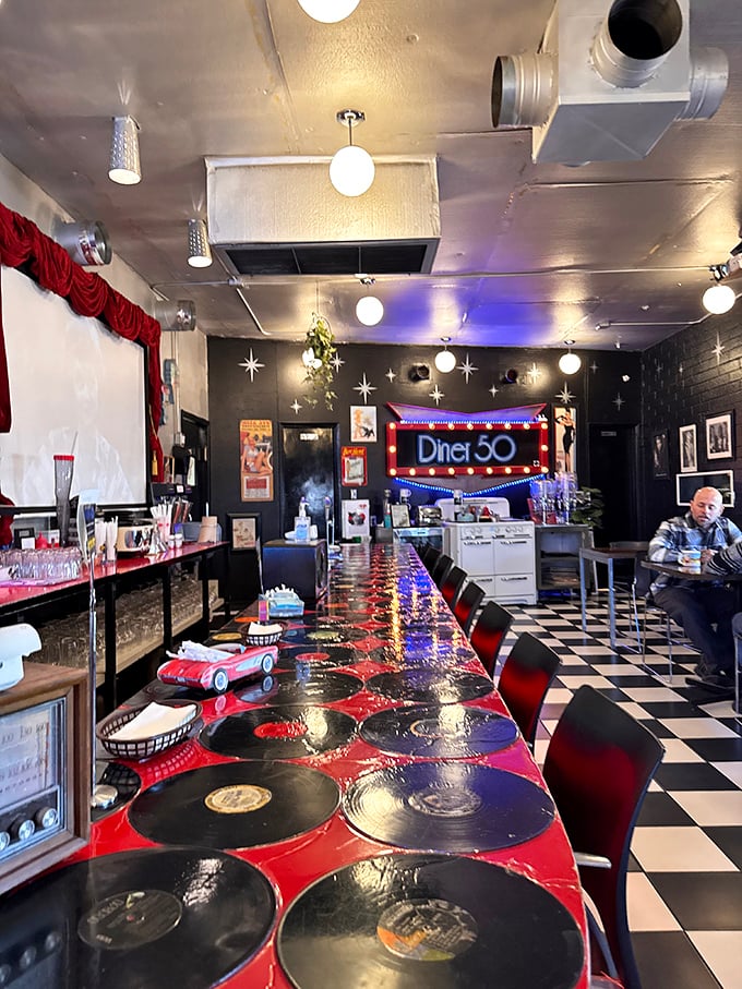The vinyl record counter at Diner 50 is the perfect metaphor: classic tracks reimagined for today's breakfast enthusiasts.